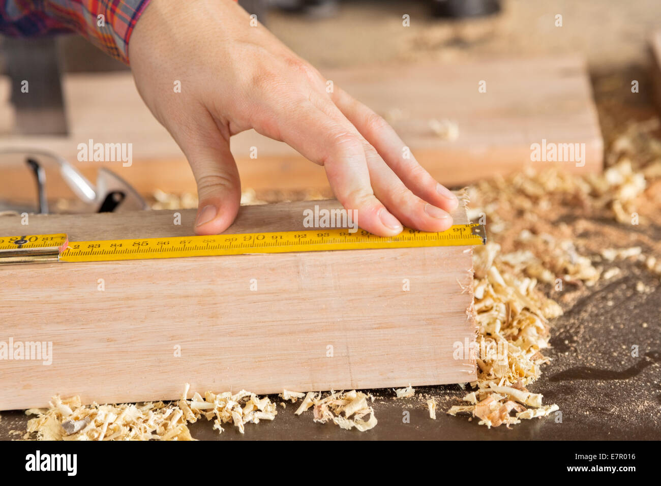Carpenter's Hand Measuring Wood With Scale Stock Photo - Alamy
