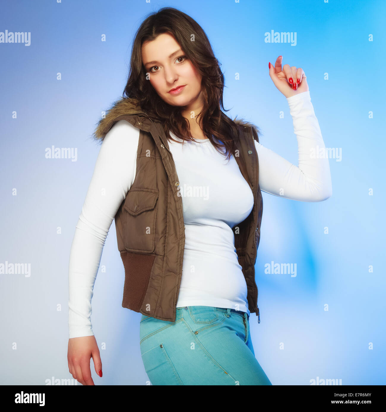 Winter fashion. Young woman plus size model posing in warm waistcoat ...