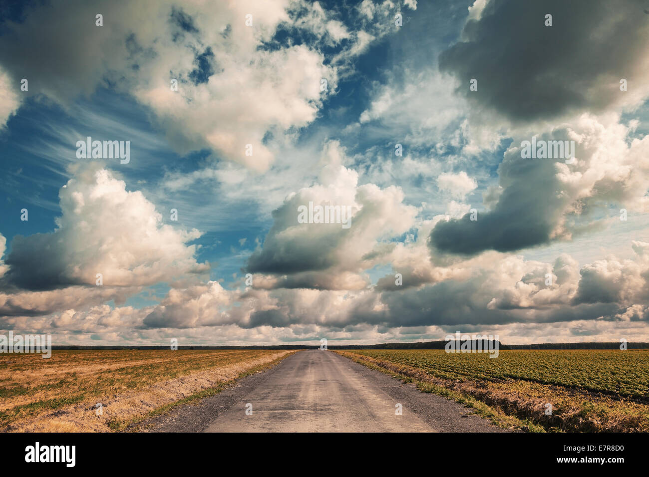 Empty country road with dramatic cloudy sky. Vintage toned effect Stock ...