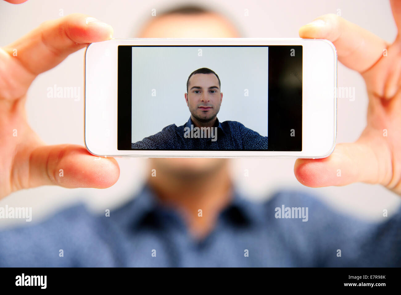 Handsome man taking selfie. Focus on smartphone Stock Photo - Alamy