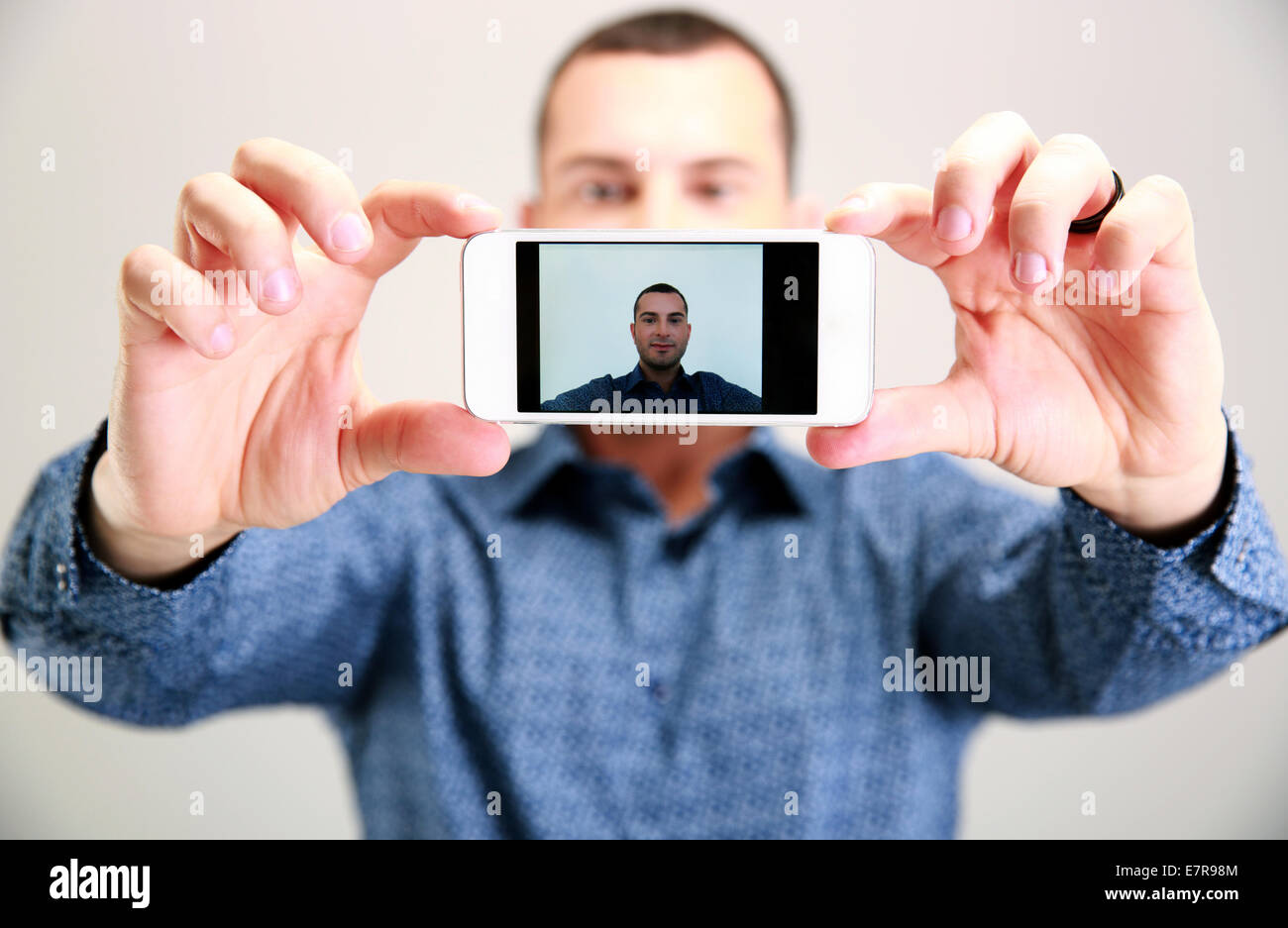 Happy man taking selfie. Focus on smartphone Stock Photo - Alamy