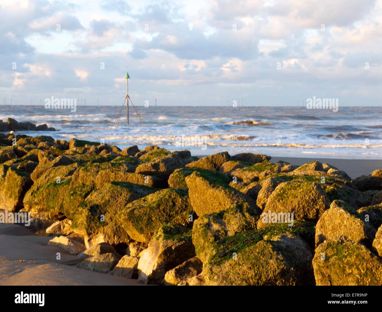 Rocks on the beach at sunset Stock Photo - Alamy