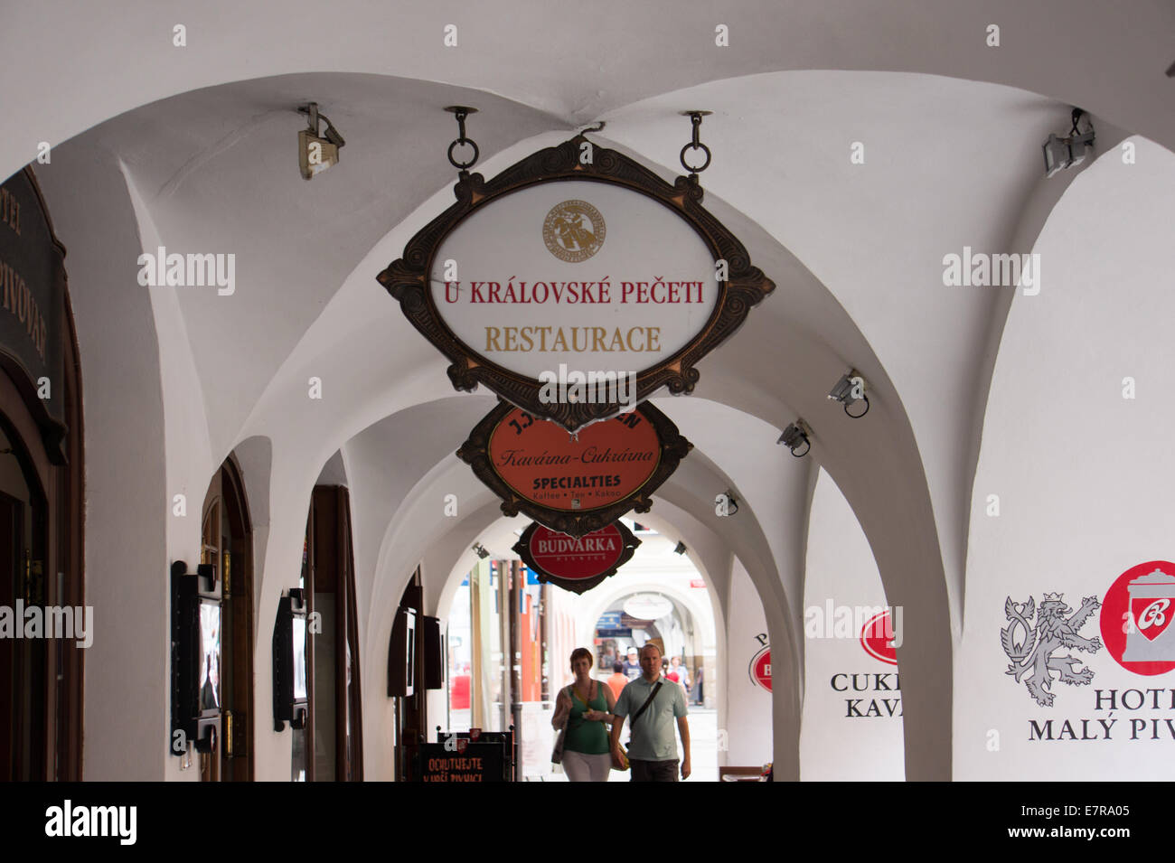 Restaurant signs hanging in an arched passage in Budweis Stock Photo ...