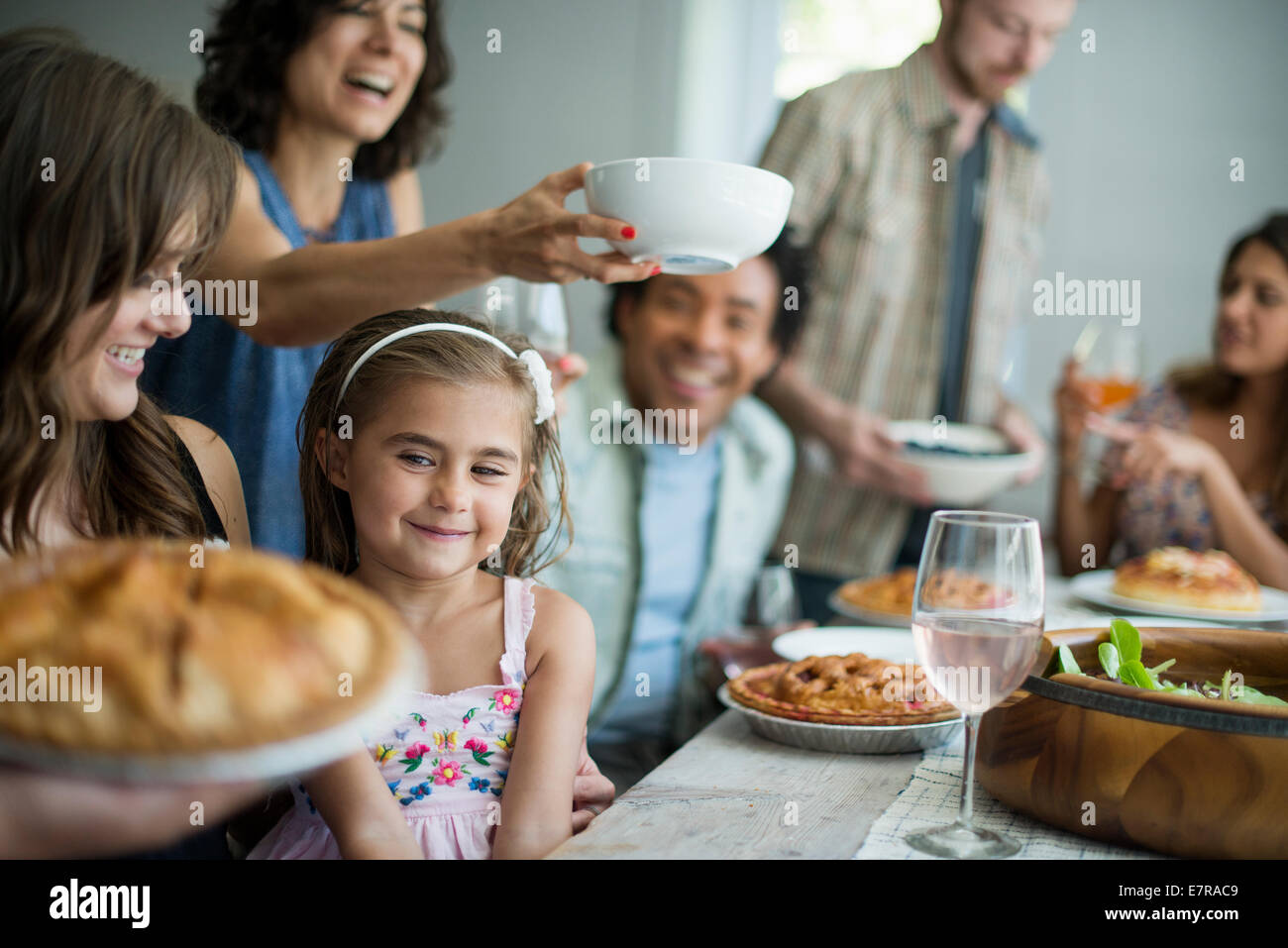 A family gathering for a meal. Adults and children around a table Stock ...