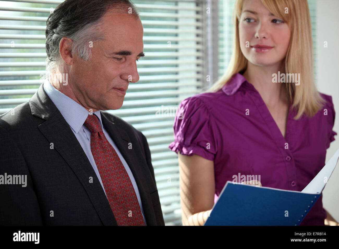 senior businessman reading a report Stock Photo - Alamy