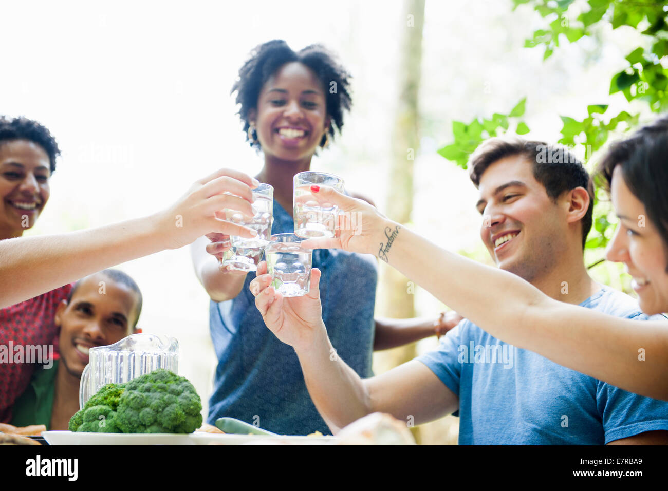 A family gathering for a meal. Adults and children around a table Stock ...