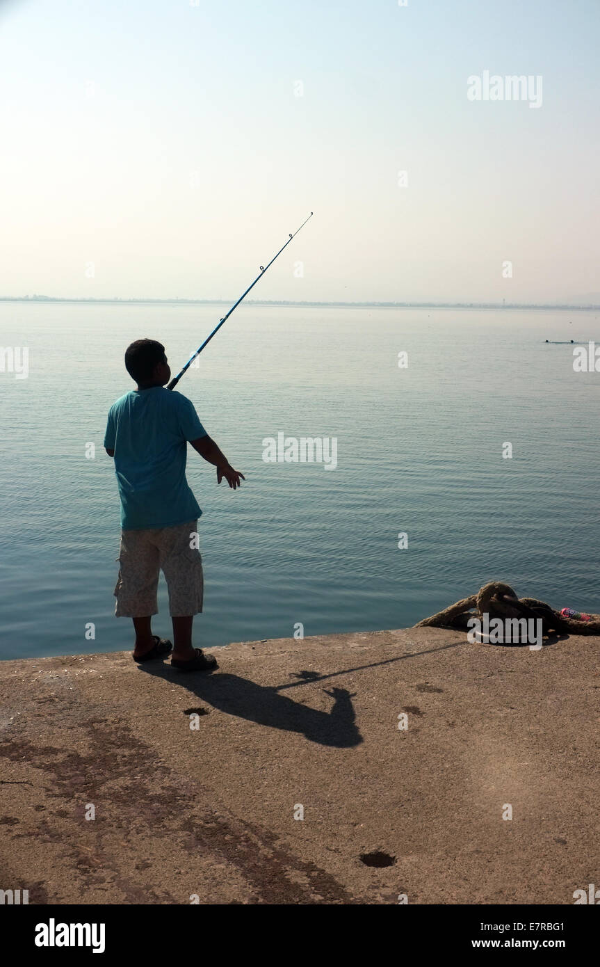 Young boy fishing with rod Stock Photo - Alamy