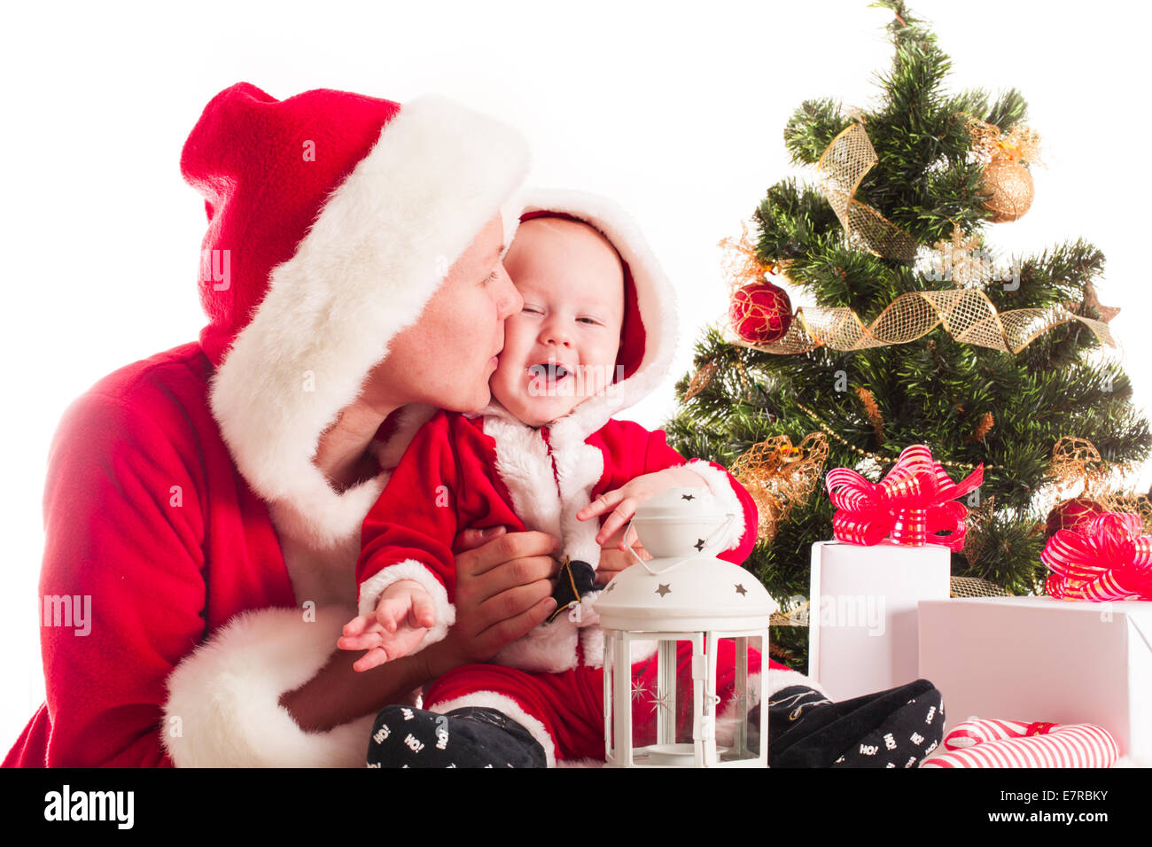 Christmas baby and mom under the fir tree isolated Stock Photo - Alamy