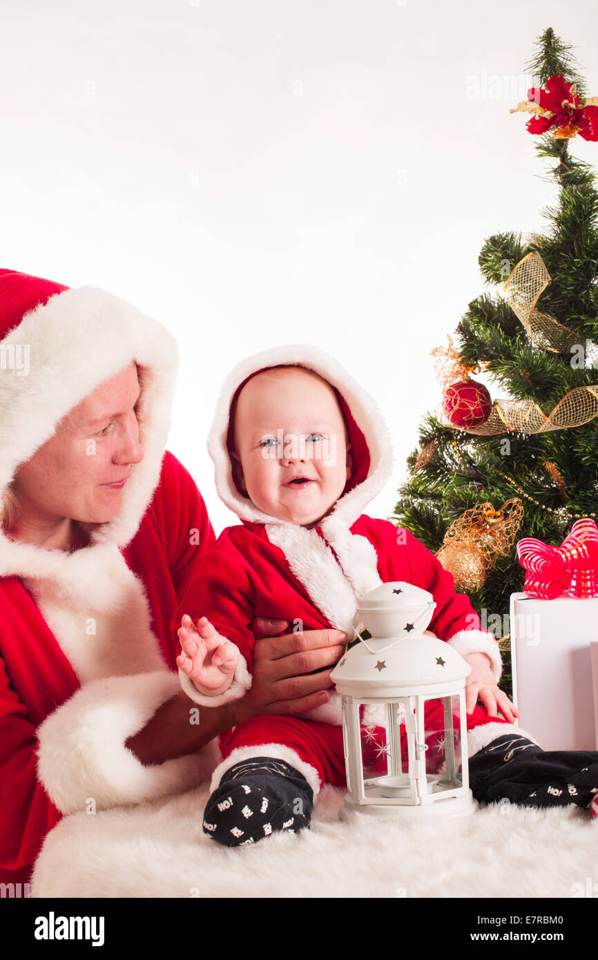 Christmas baby and mom under the fir tree isolated Stock Photo - Alamy