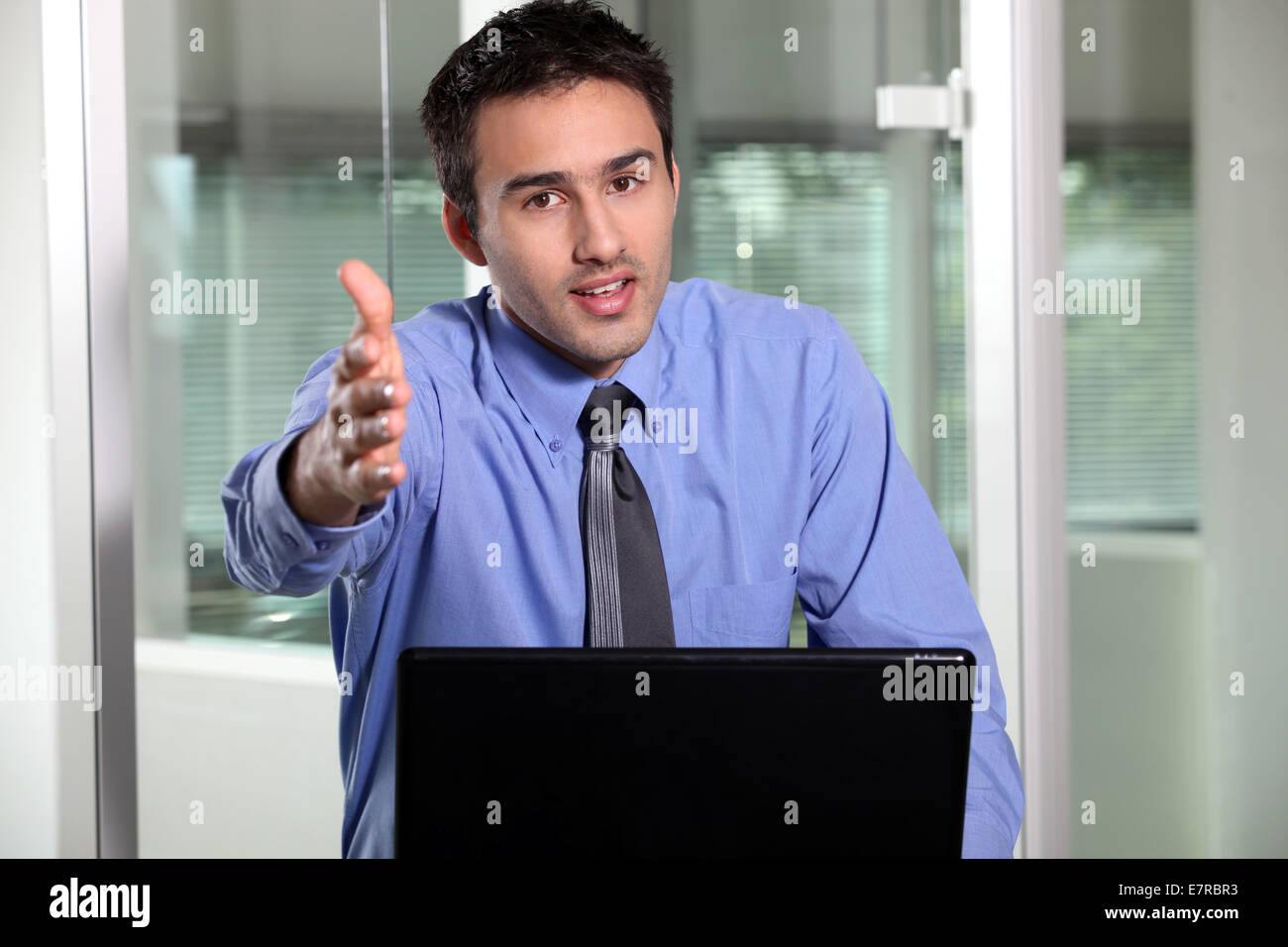 Businessman holding his hand out Stock Photo - Alamy