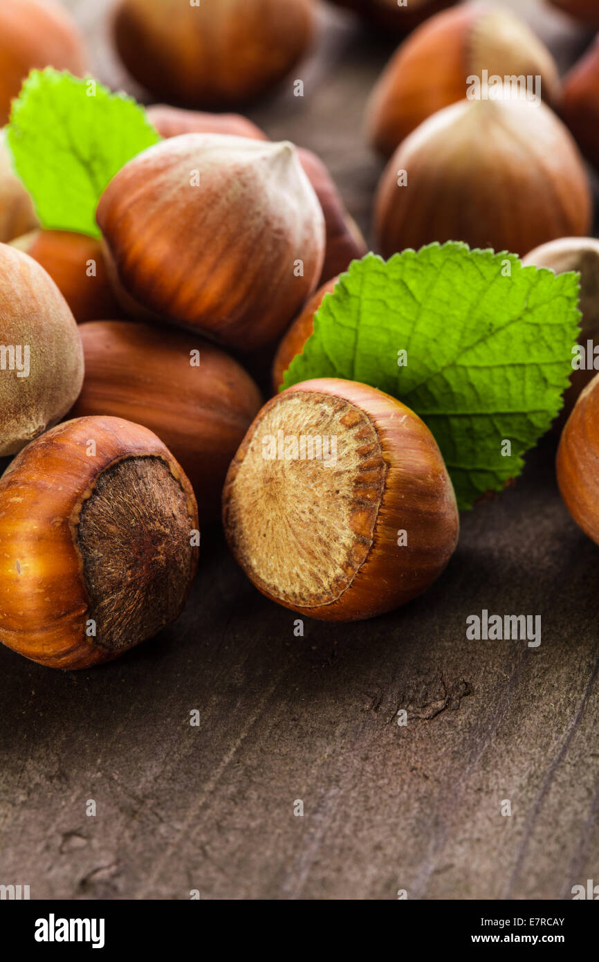 Hazelnuts with shell and green leaf on the wooden table Stock Photo - Alamy