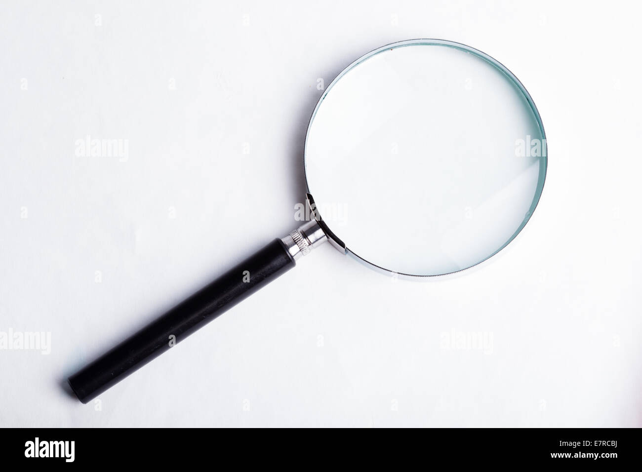 Glass magnifier closeup on a blue background Stock Photo - Alamy