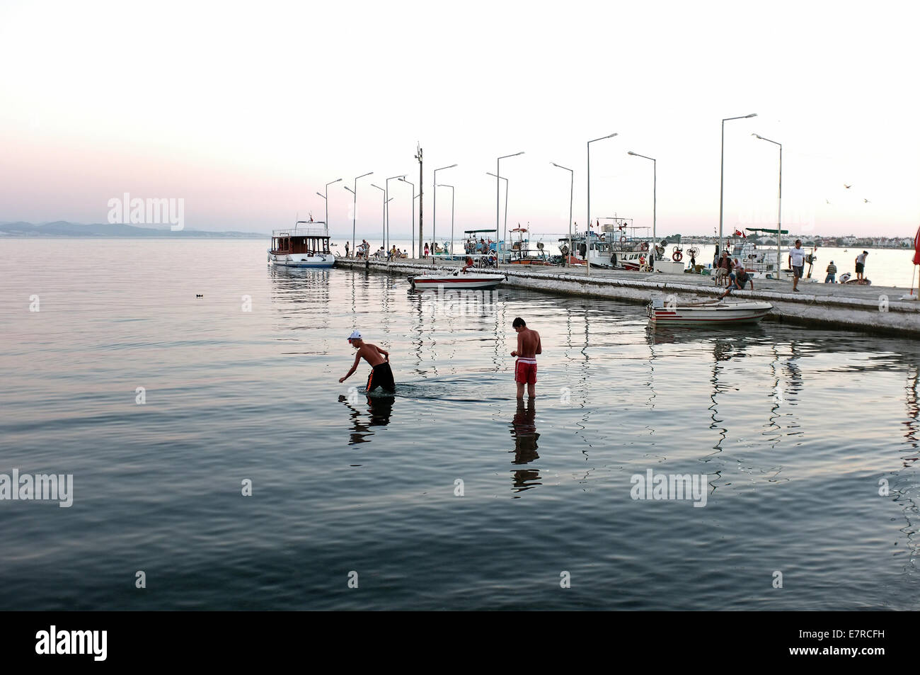 People enjoy their time around pier Stock Photo - Alamy