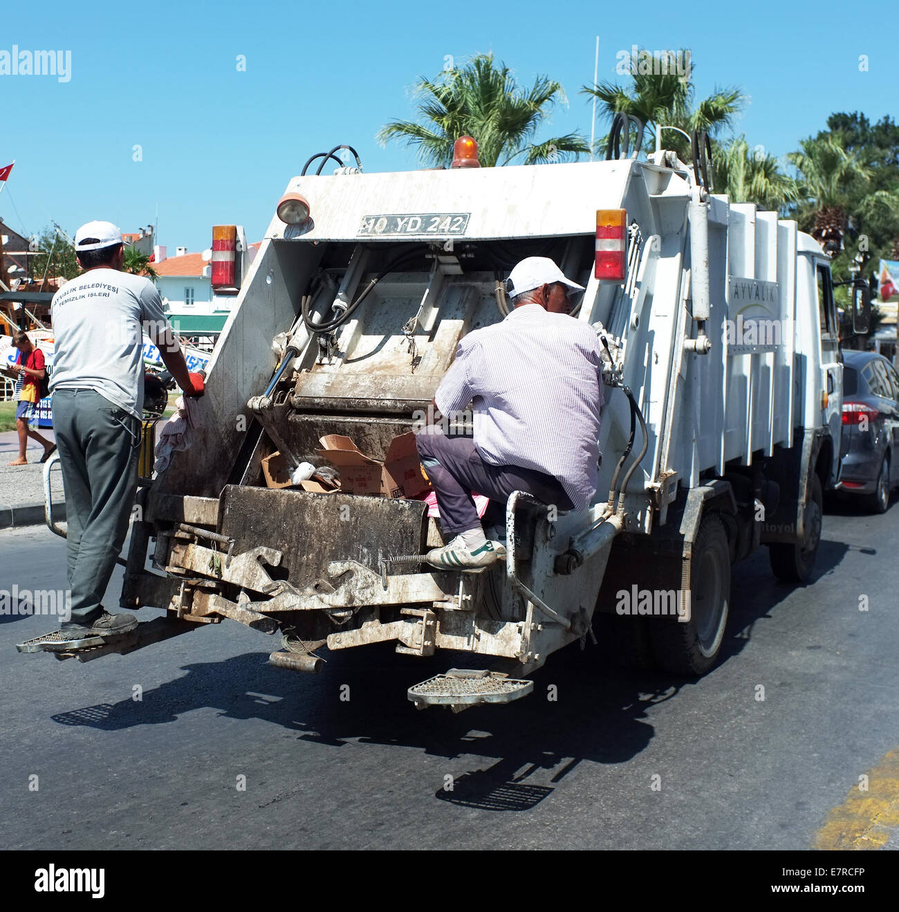Garbage men behind the garbage truck Stock Photo - Alamy