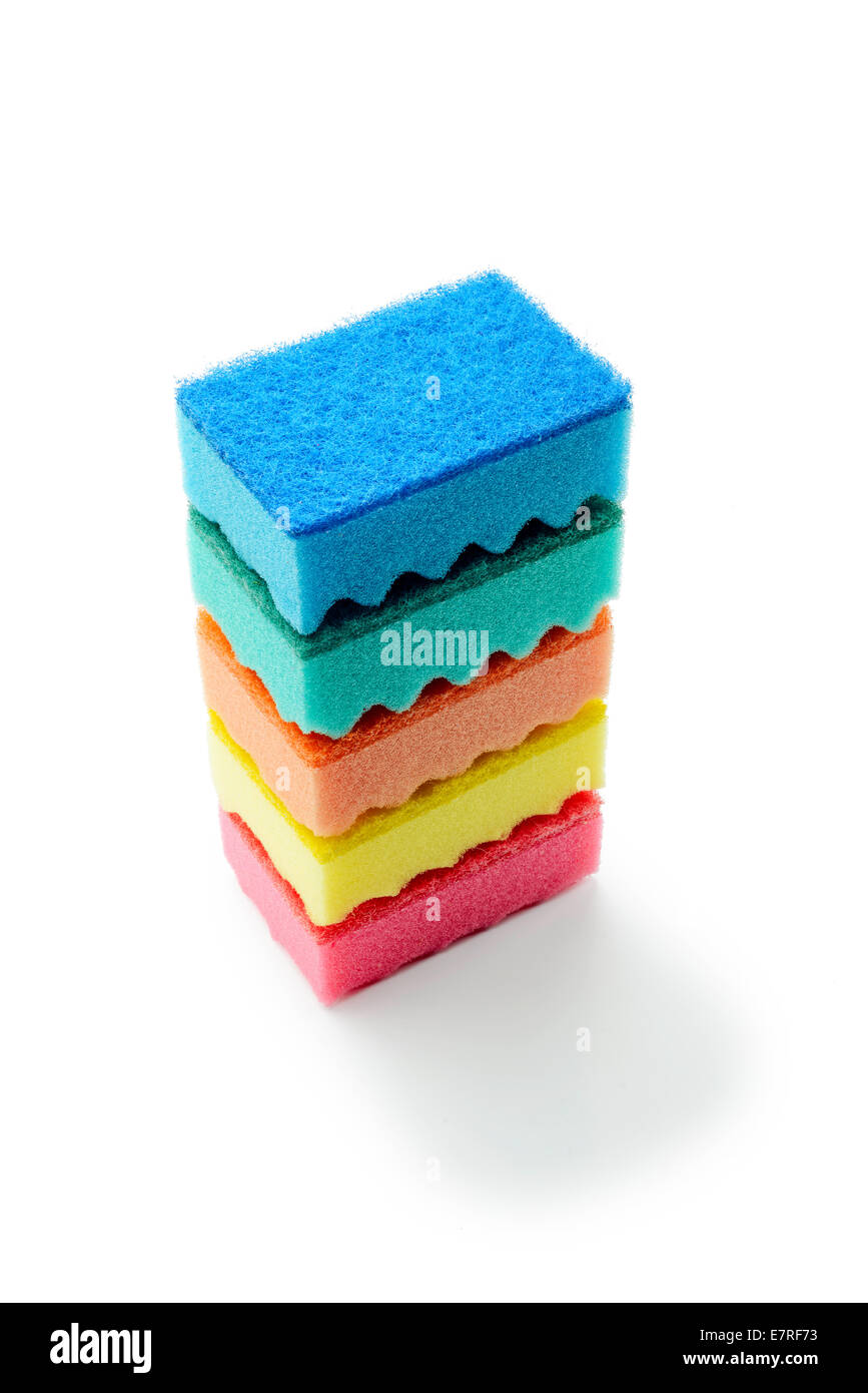 A stack of multicolored kitchen sponges isolated on white background ...