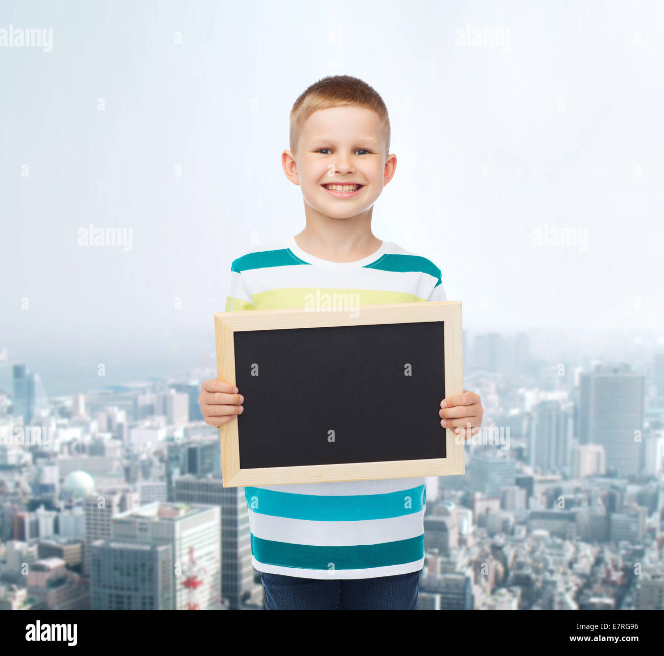 smiling little boy holding blank black chalkboard Stock Photo - Alamy