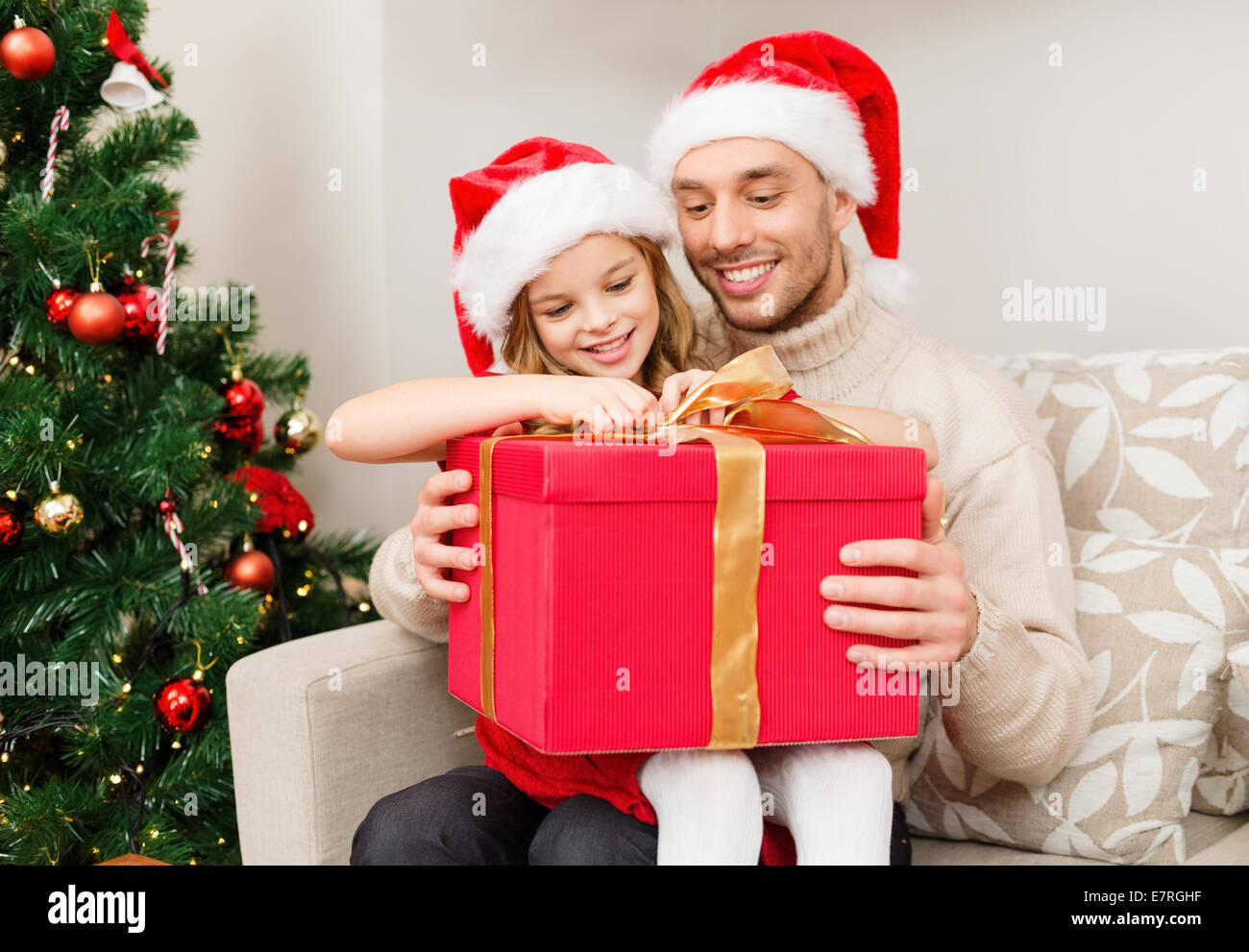 smiling father and daughter opening gift box Stock Photo - Alamy
