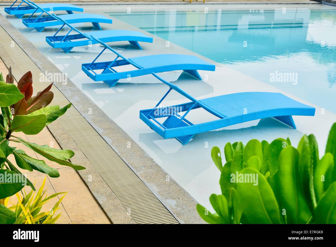 Turquoise pool benches in Philippine hotel Stock Photo - Alamy