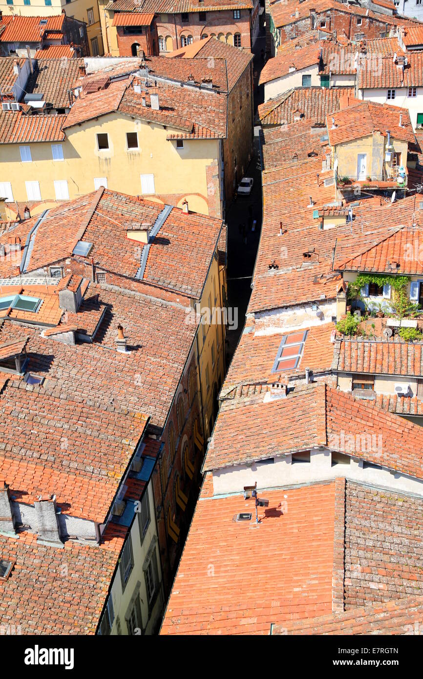 A street cutting through old buildings in Lucca, Italy Stock Photo - Alamy