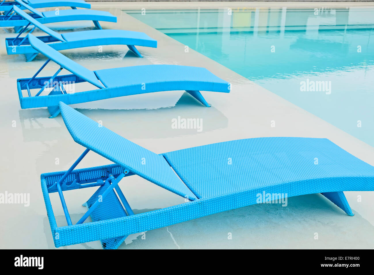Turquoise pool benches in Philippine hotel Stock Photo - Alamy