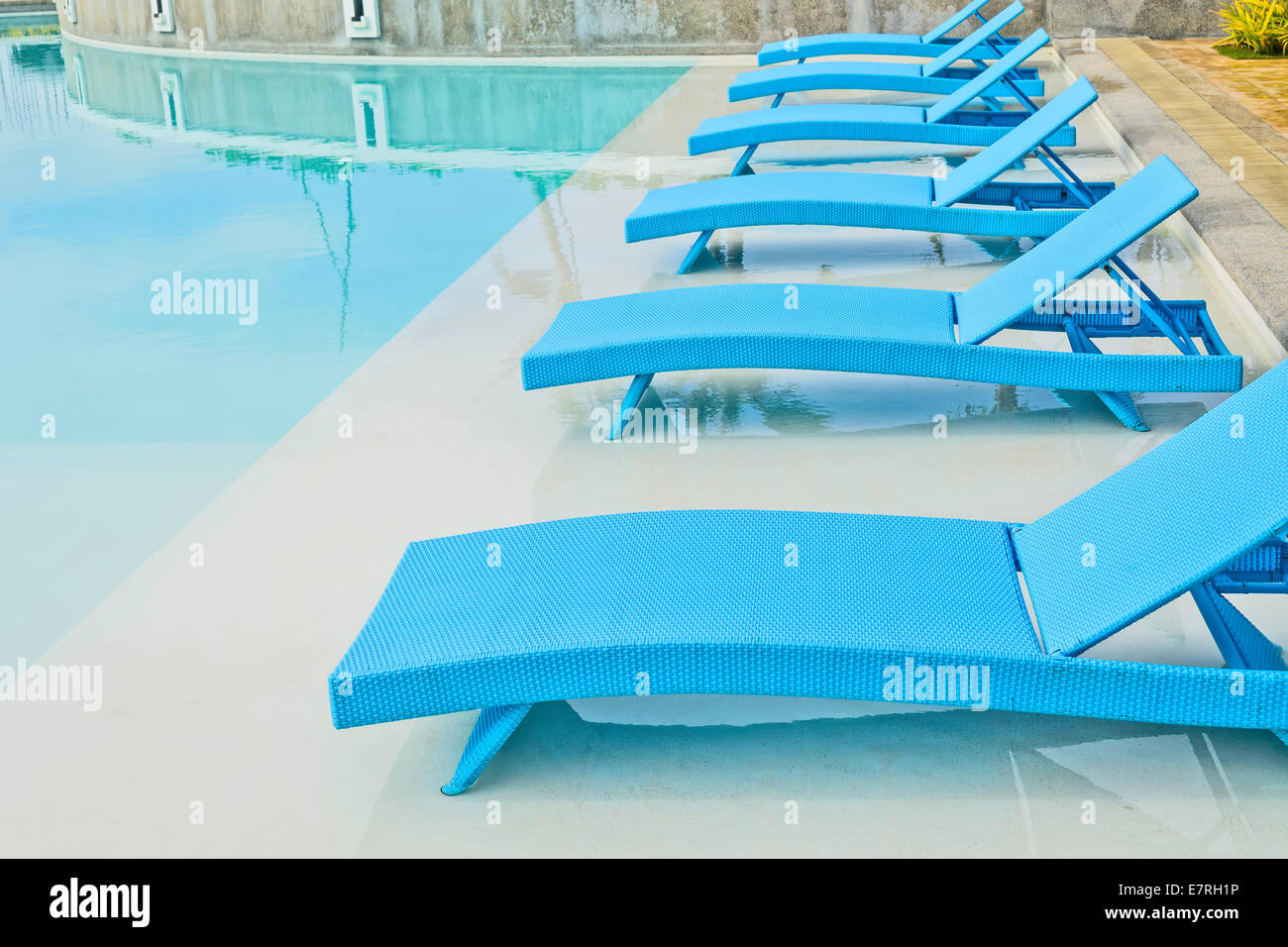 Turquoise pool benches in Philippine hotel Stock Photo - Alamy