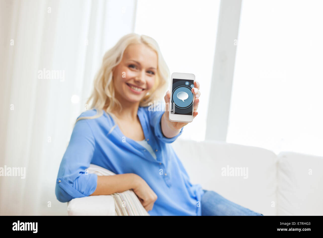 smiling woman with smartphone at home Stock Photo - Alamy