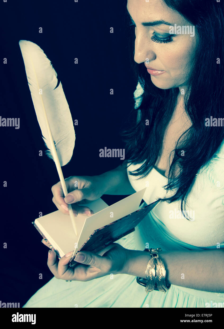 Romantic looking woman writing a diary with a quill Stock Photo - Alamy