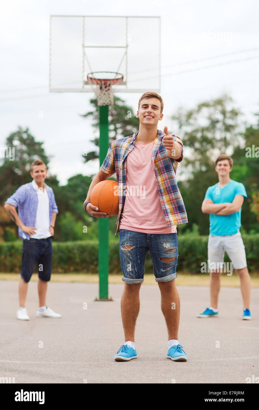 group of smiling teenagers playing basketball Stock Photo - Alamy