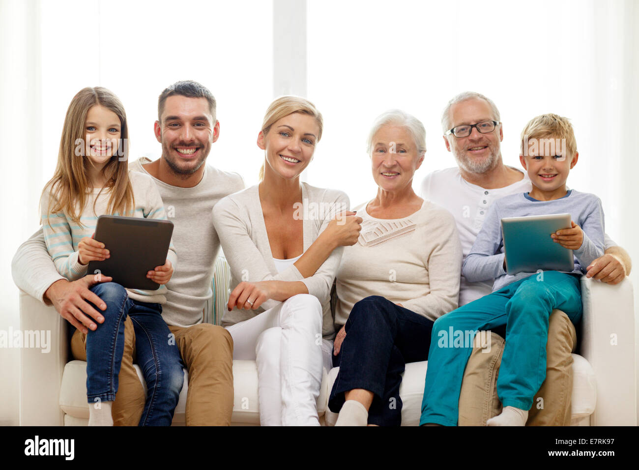 smiling family with tablet pc at home Stock Photo - Alamy