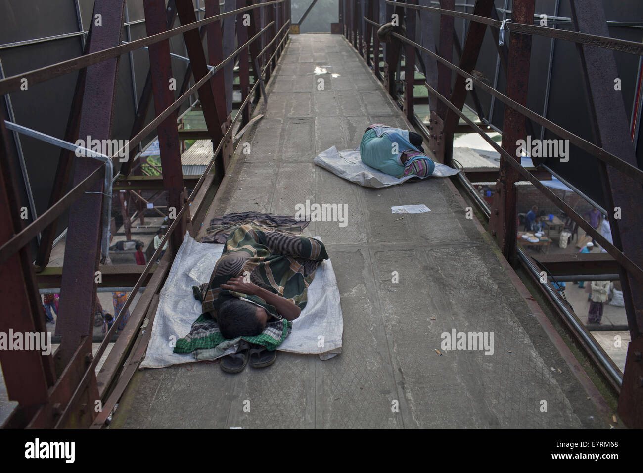 Oct. 12, 2013 - Homeless people sleep at a railway station in Dhaka. A ...