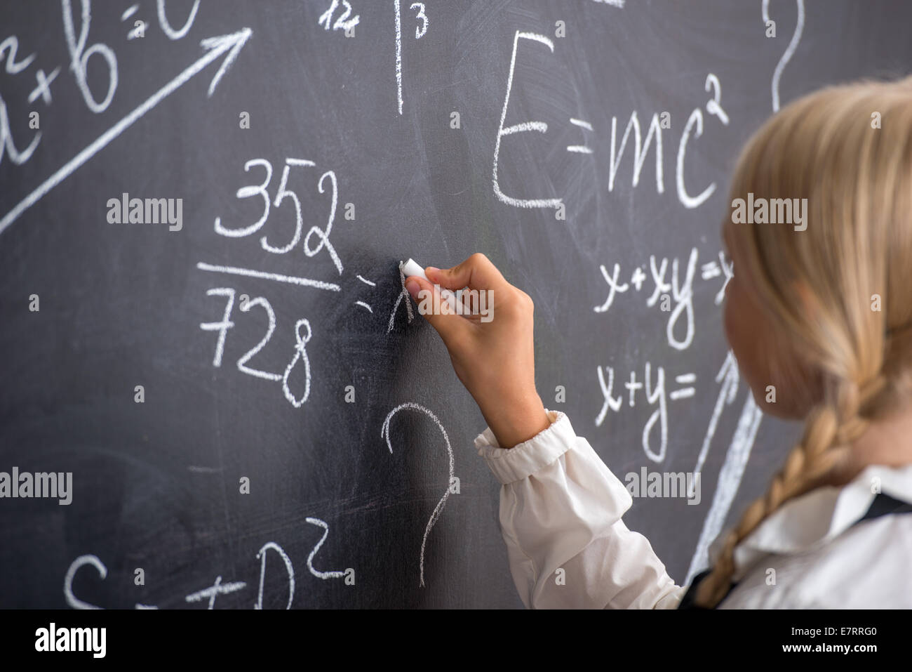 School girl writing on blackboard Stock Photo - Alamy