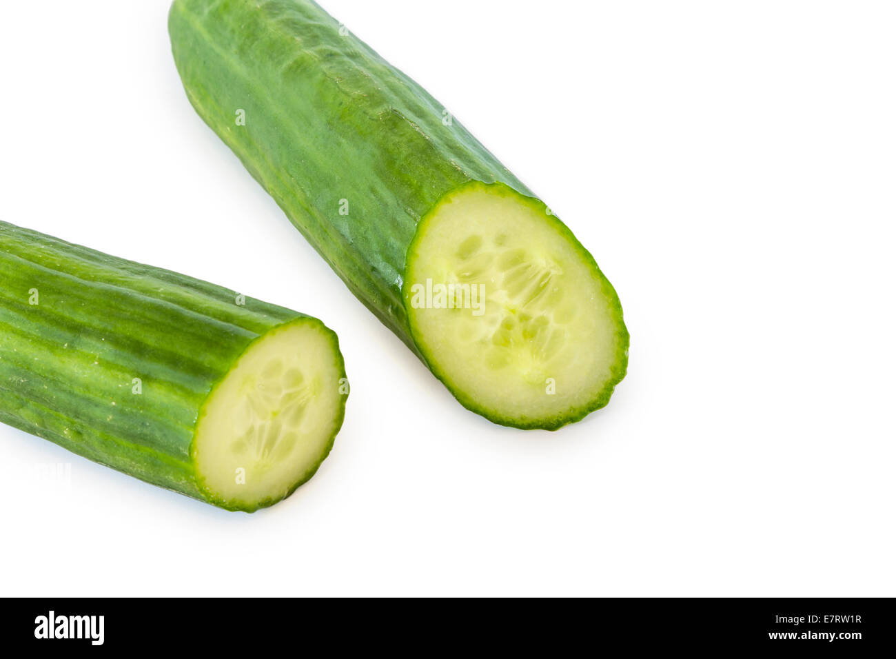 a cucumber divide in half isolated on white background Stock Photo - Alamy