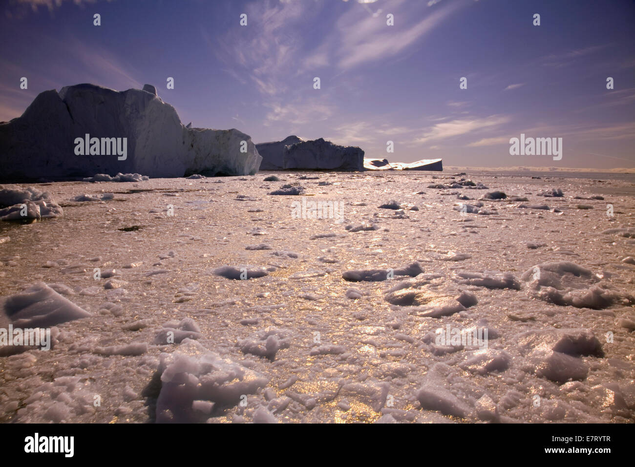 A delicate arch of ice collapses from a giant iceberg dislodged from ...