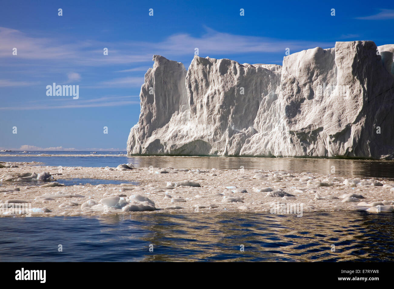 A delicate arch of ice collapses from a giant iceberg dislodged from ...