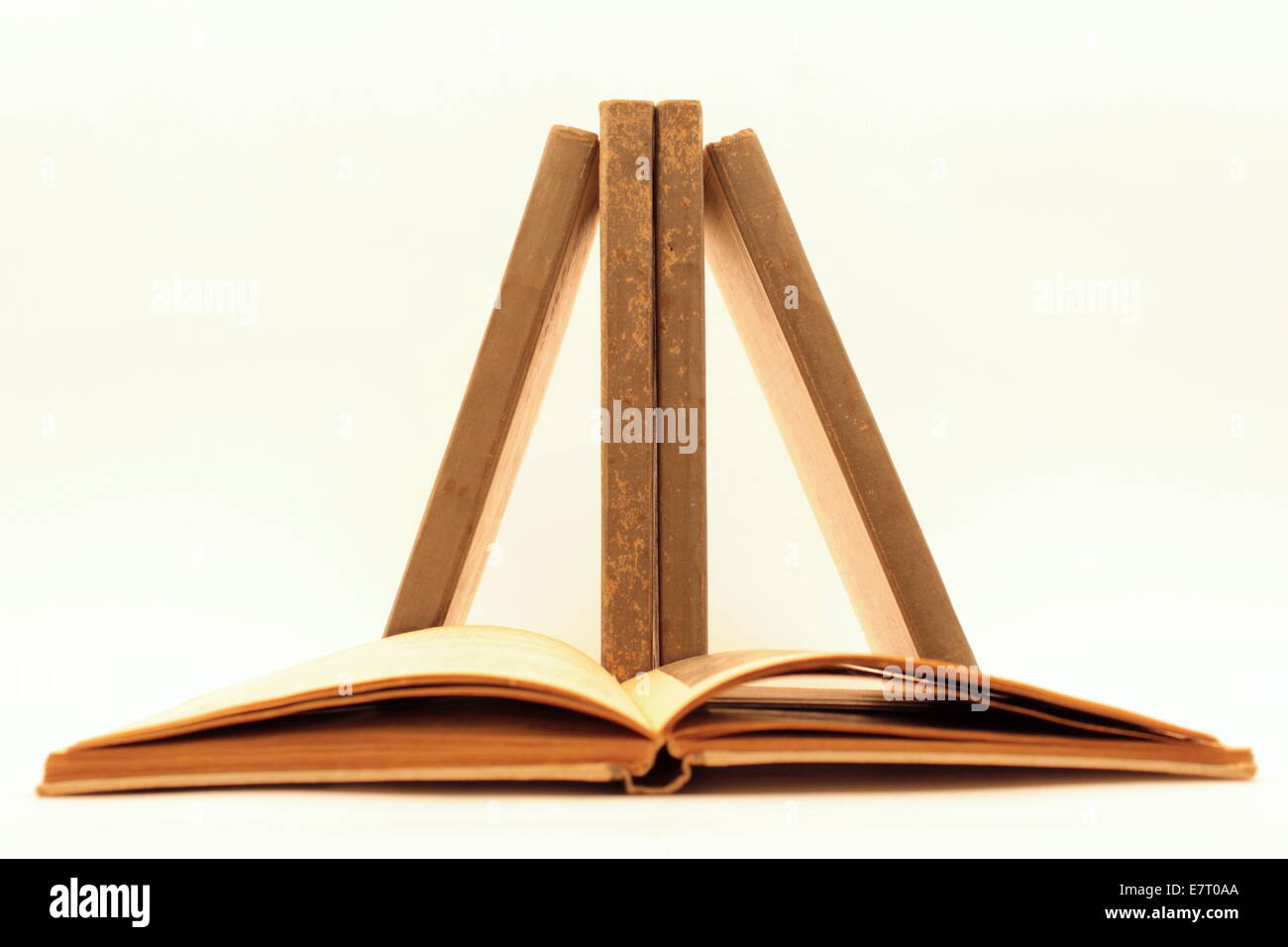 Open book and four vertically above white background Stock Photo - Alamy