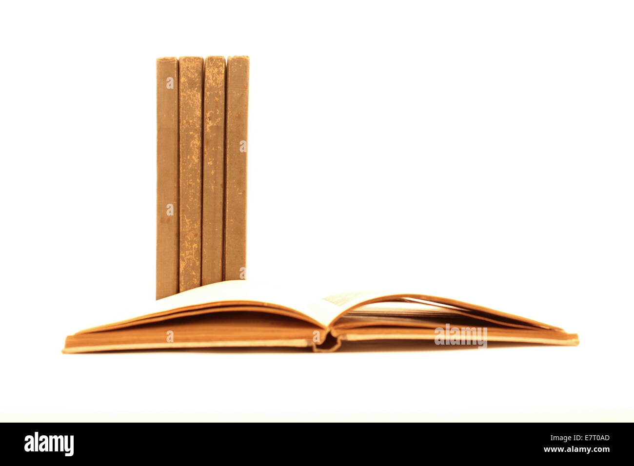 Open book and four vertically above white background Stock Photo - Alamy