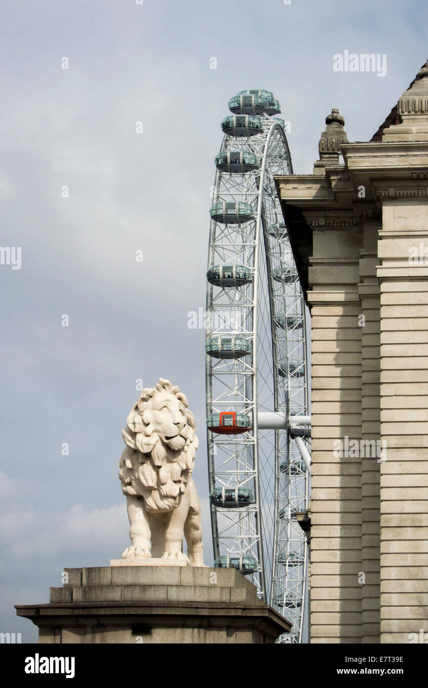 View of the London Eye with a statue of a lion in the foreground Stock ...
