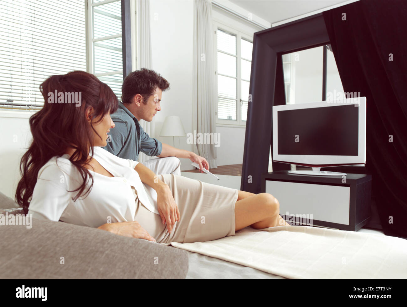 happy couple sitting on couch and watching television together Stock ...