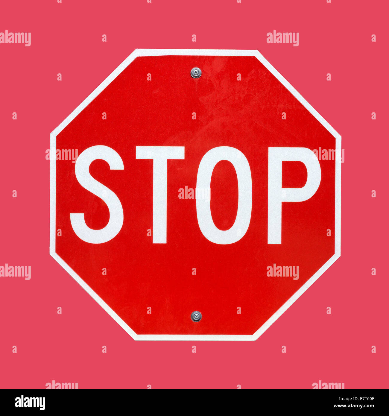 A Bright Red And White Stop Sign On A Subdued Red Background Stock a-bright-red-and-white-stop-sign-on-a-subdued-red-background-stock