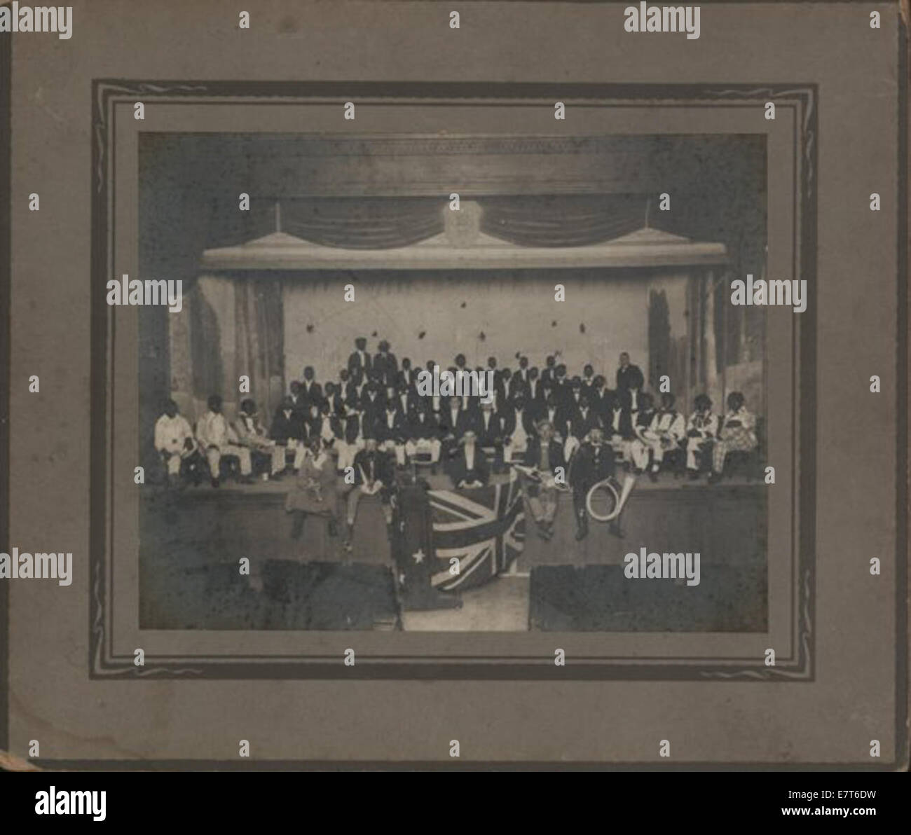 A photograph of a minstrel performer in a music hall, captured during ...