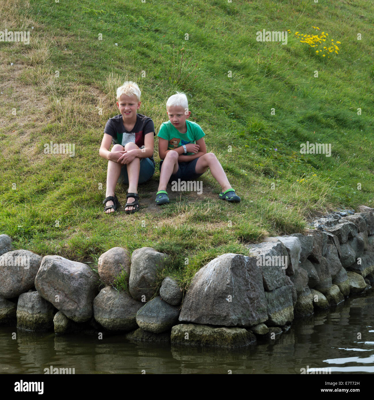 Two boys watching the ducks, Rosenborg Castle, Copenhagen, Denmark ...