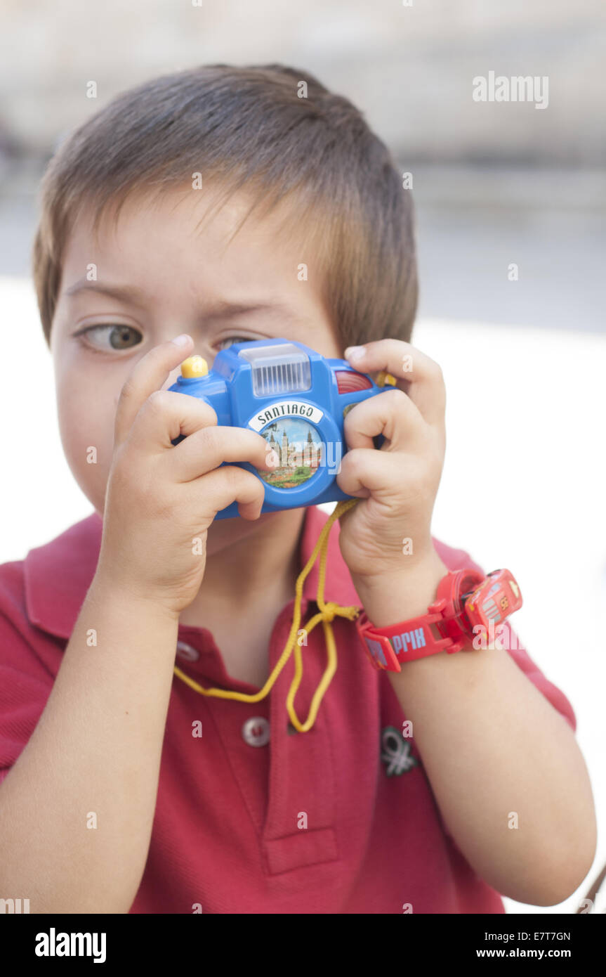 four year old toddler playing with a plastic camera Stock Photo - Alamy