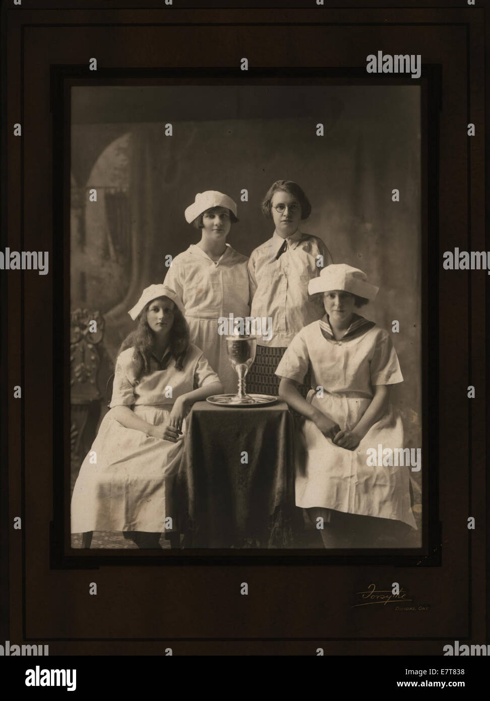 A portrait photograph of a group of young women, captured in a formal ...
