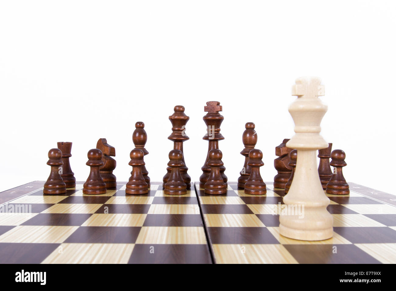 Chess pieces in a row on board against king, isolated on white ...