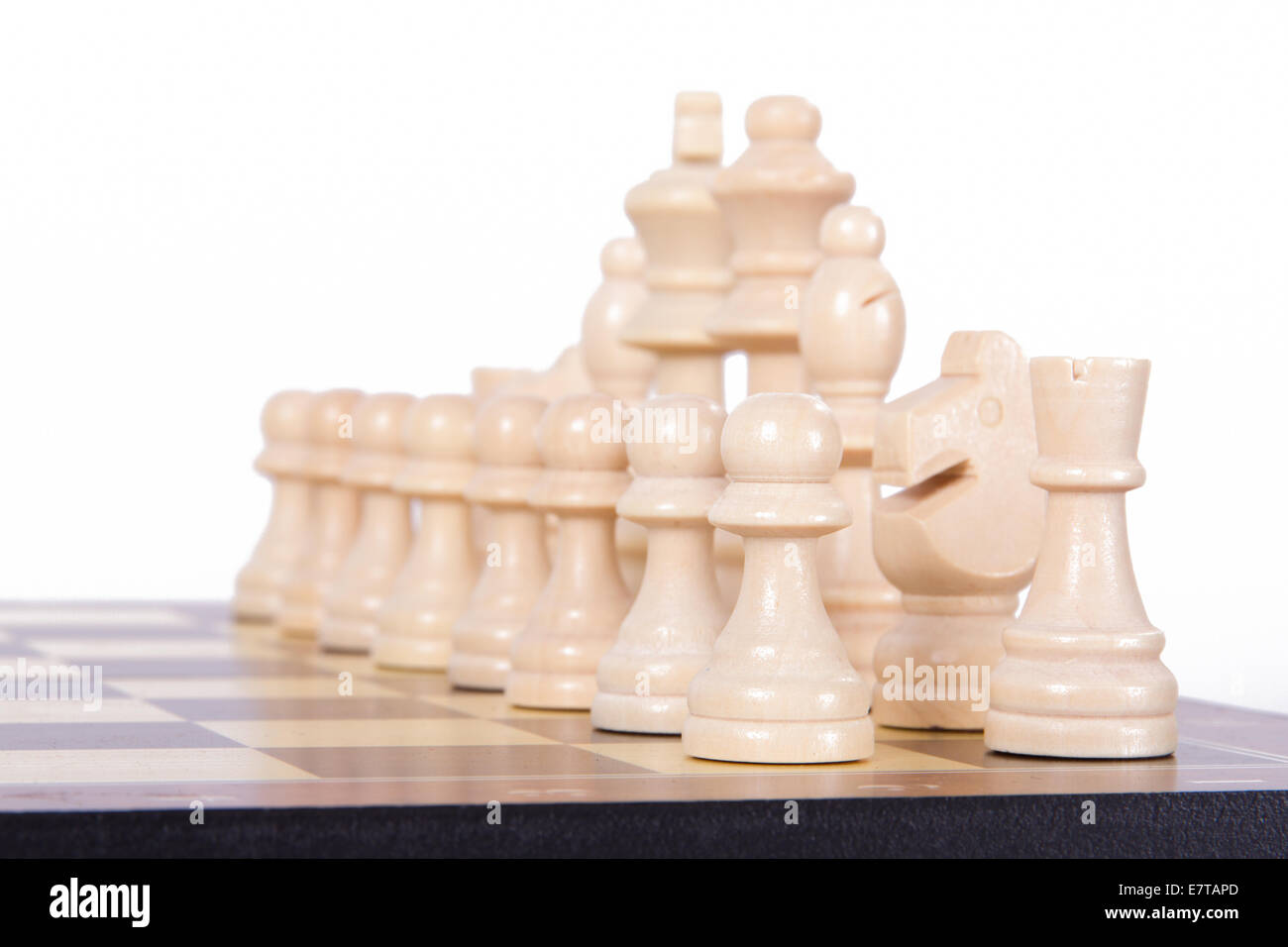 Chess board with starting positions aligned wooden chess pieces ...