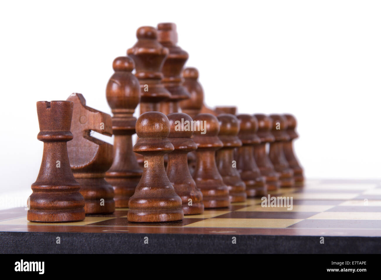 Chess board with starting positions aligned dark wooden chess pieces ...