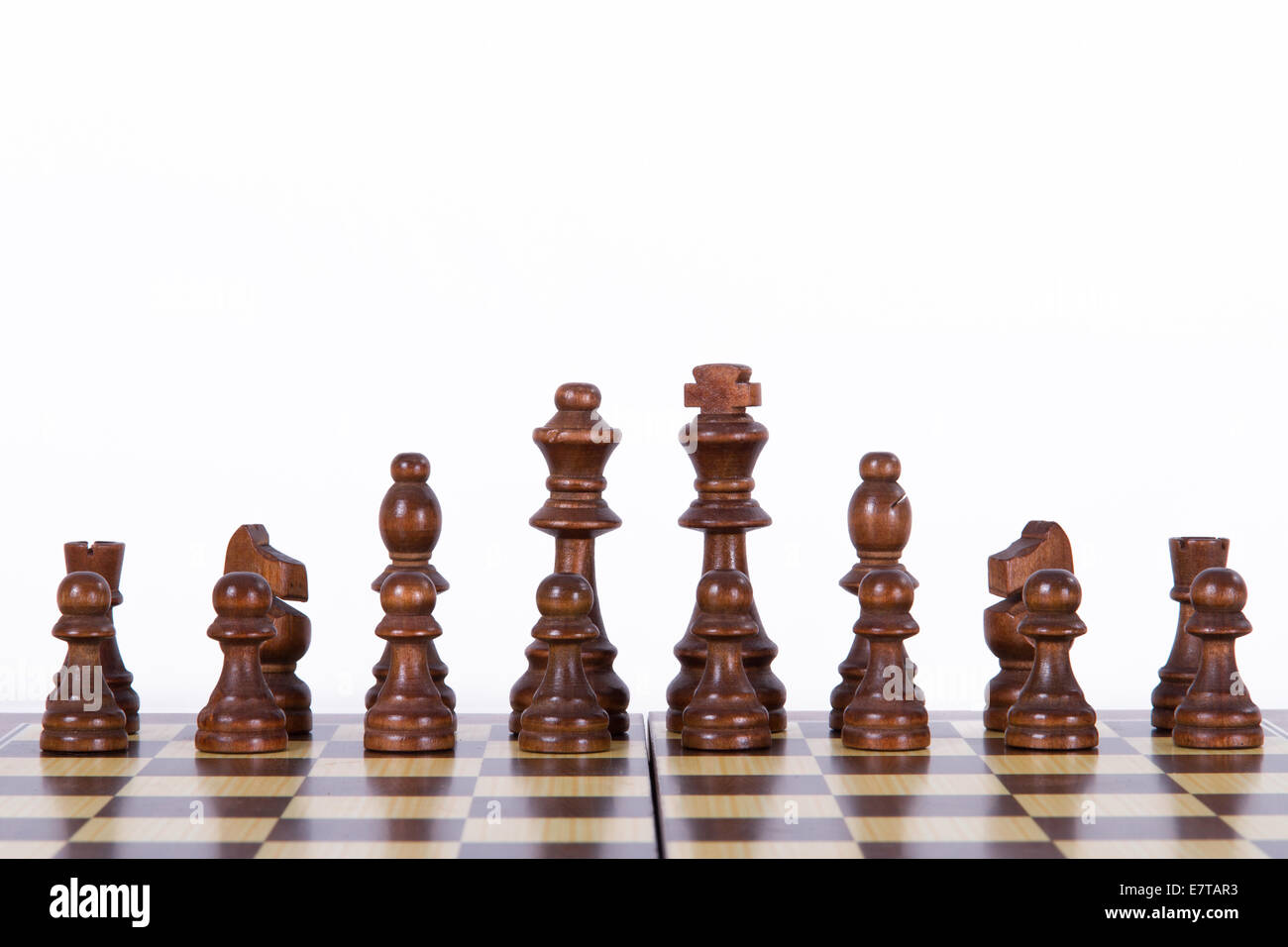 Full set of dark brown chess pieces on board, isolated on white ...
