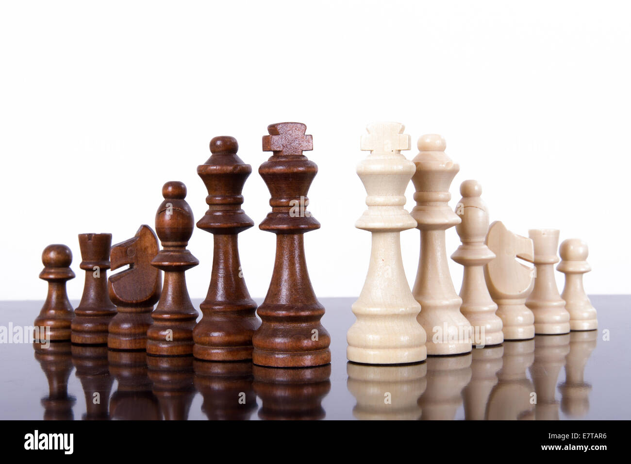 Chess pieces in a row on dark table, isolated on white background Stock ...