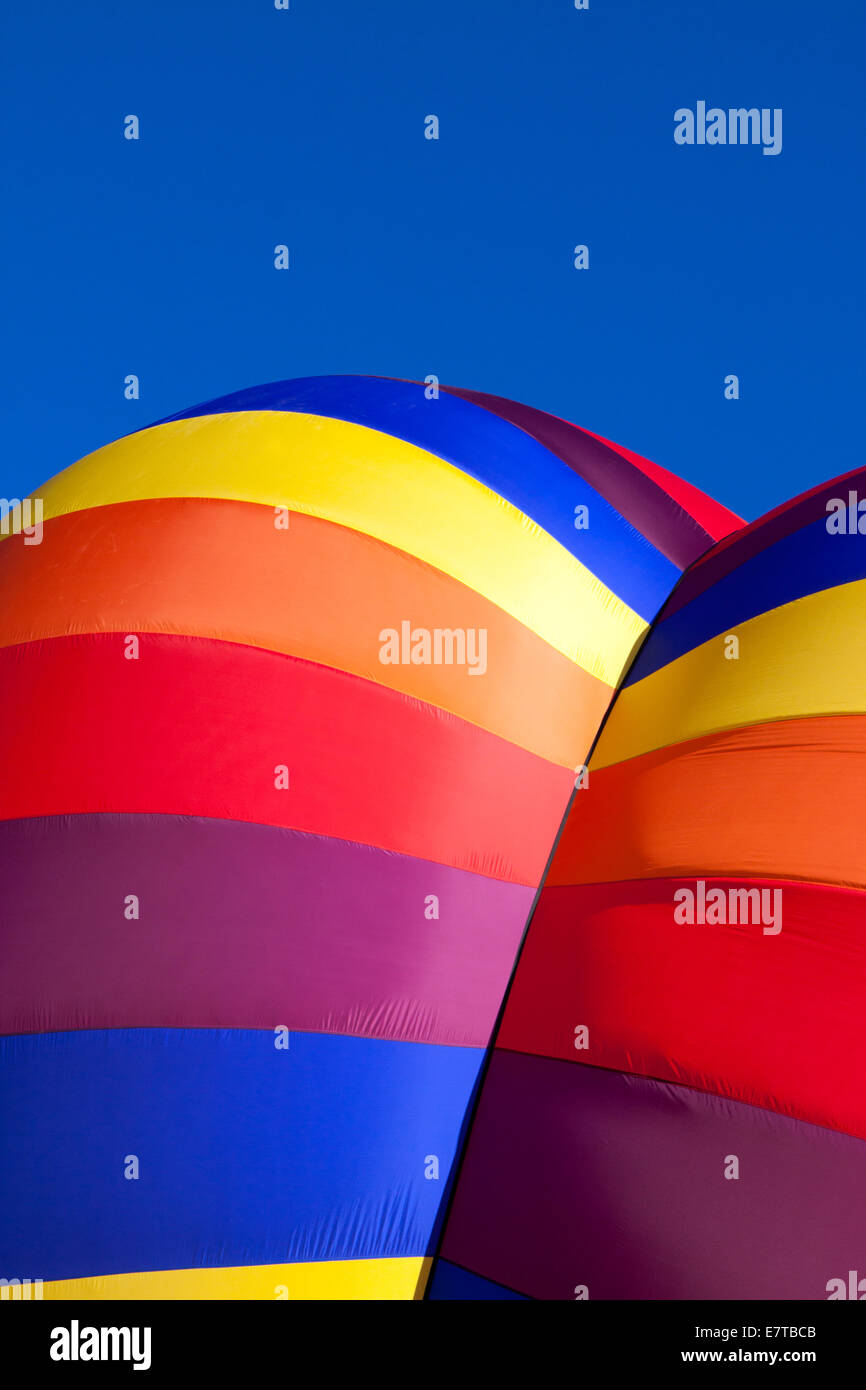 Closeup of a brightly striped hot air balloon canopy against a dark ...