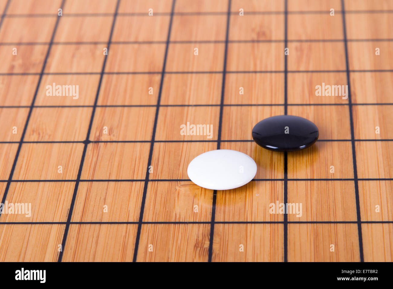 Close up view of black and white stone pieces on Chinese go game board ...